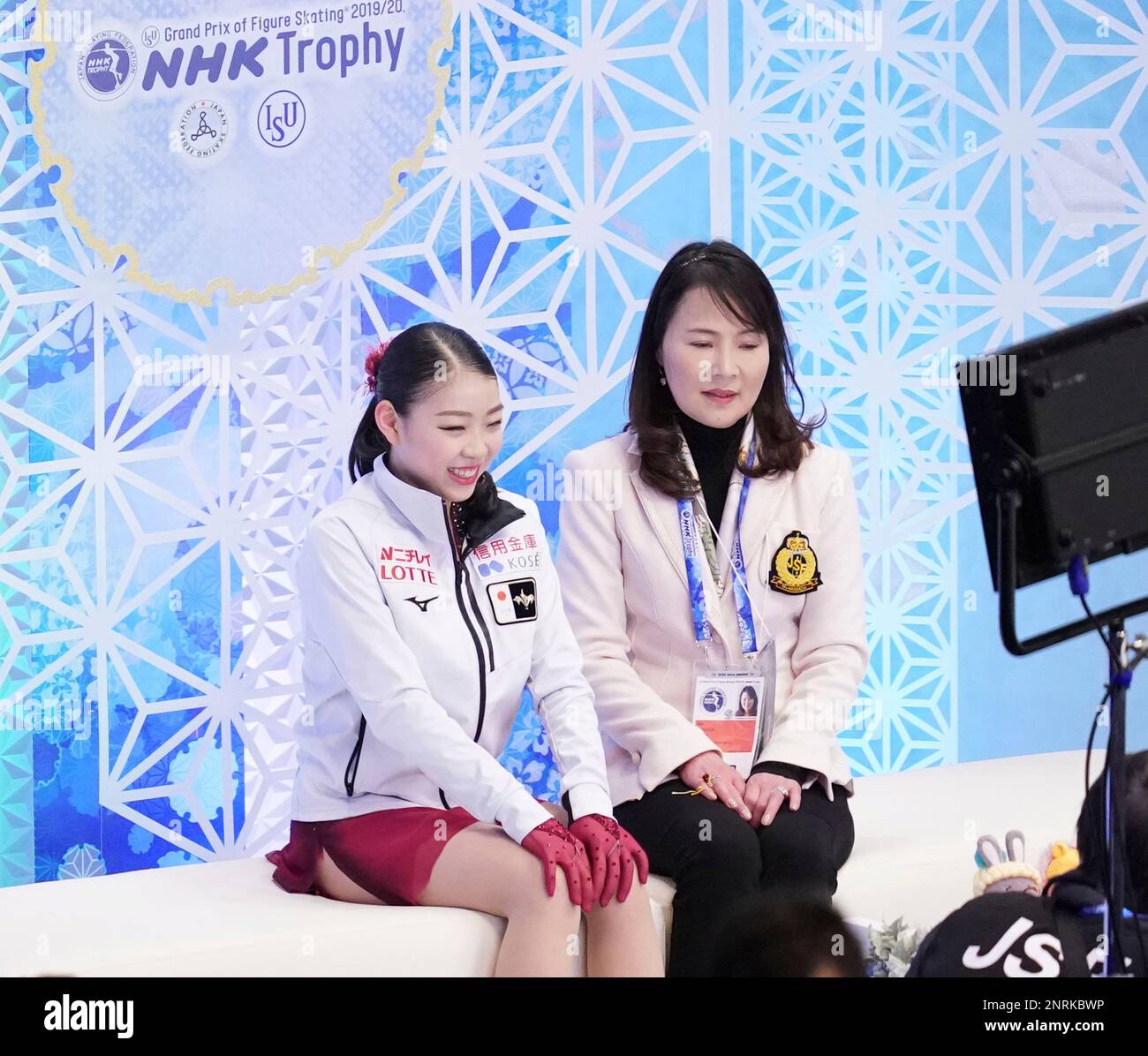 Japanese figure skating coach Mie Hamada (R) sits with Rika Kihir at ...