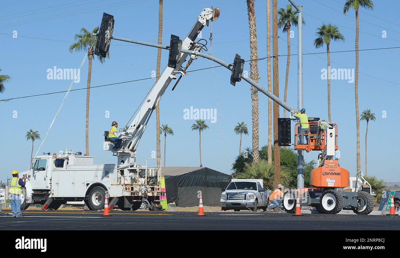 Workers assemble a traffic signal in the southbound lane of U.S. 95 at ...