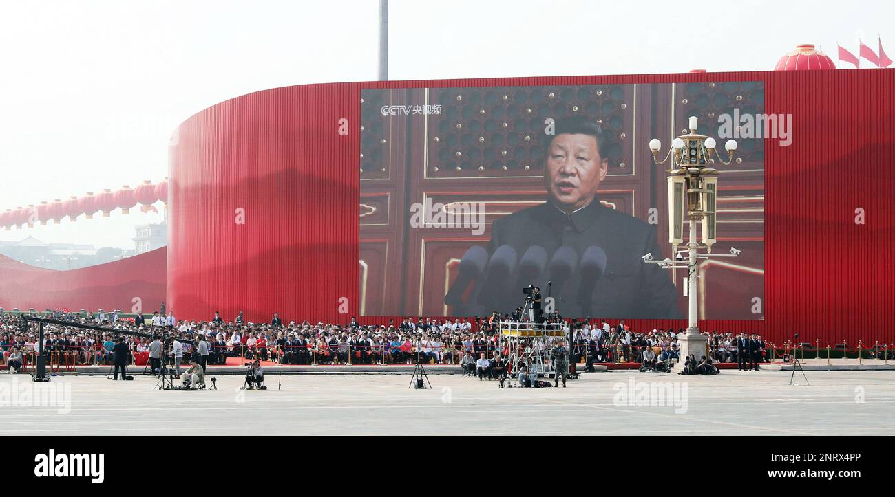 A monitor shows China's President Xi Jinping attending a military ...