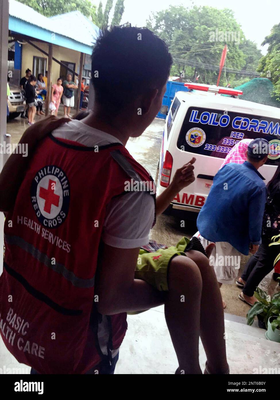 In this photo provided by the Philippine Red Cross, a rescue worker ...