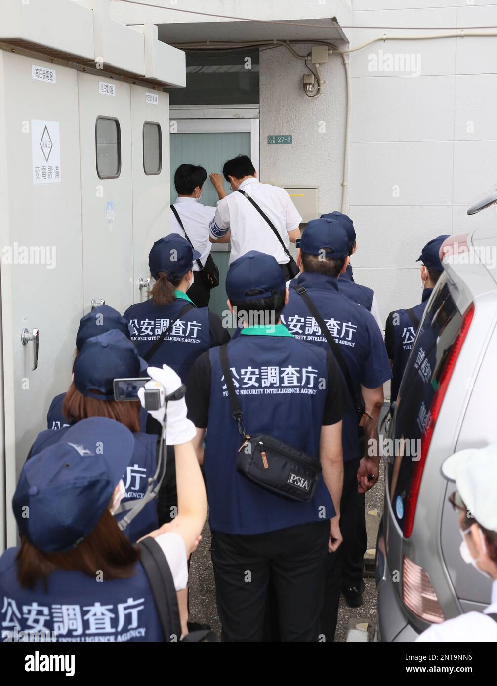 Police officers enter Aleph, the group whose name was changed from Aum ...