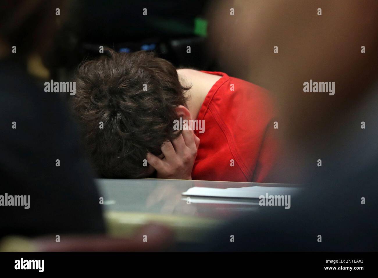 School shooting suspect Nikolas Cruz plugs his ears and ducks his head ...