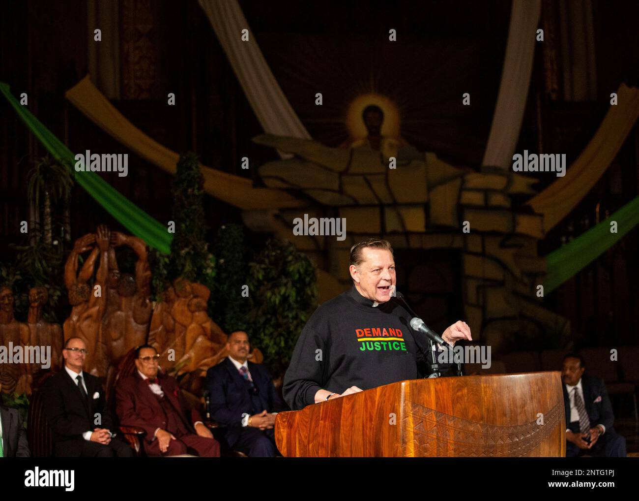 Minister Louis Farrakhan, of the Nation of Islam, listens as Father ...