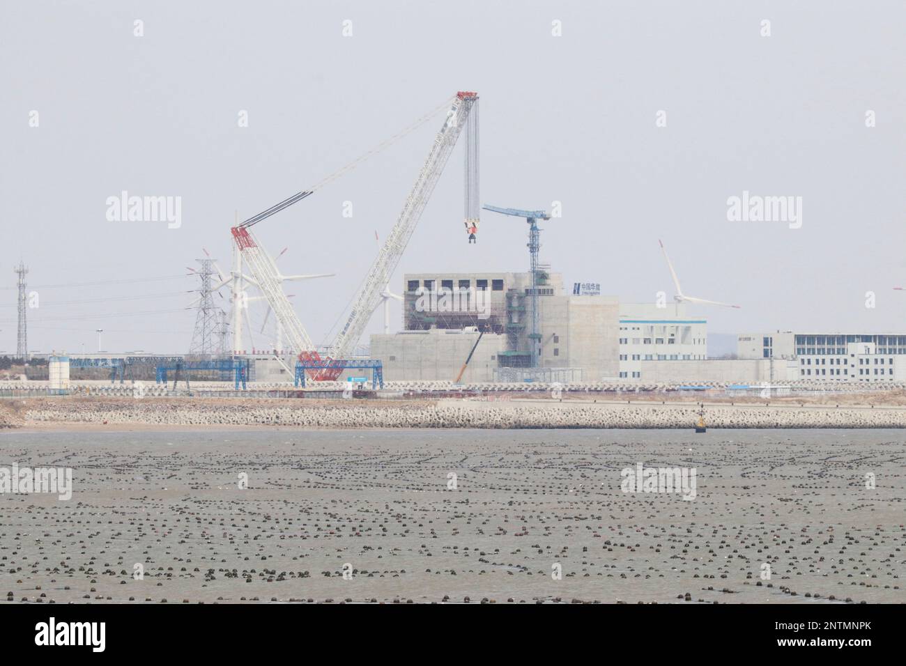 A photo shows Shidao Bay Nuclear Power Plant under construction in ...