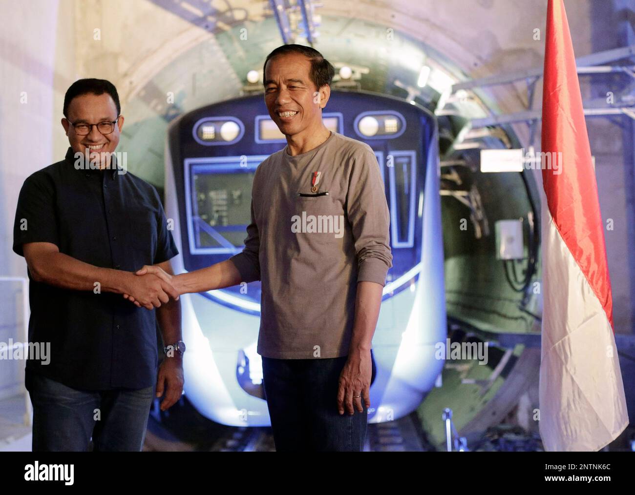 Indonesian President Joko “Jokowi” Widodo, right, shakes hands with ...