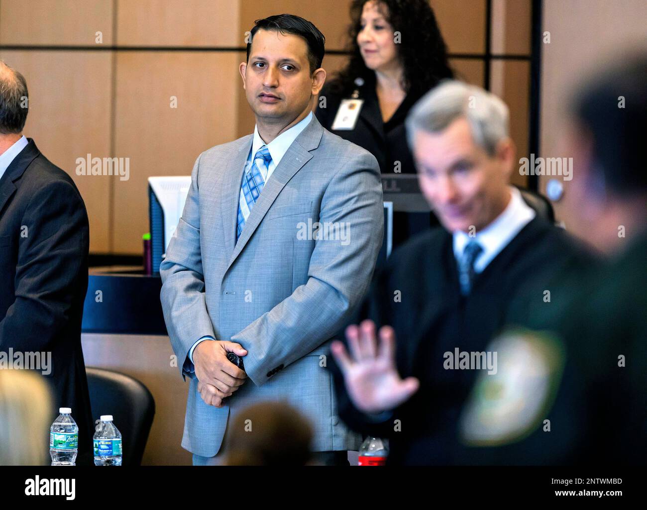 Nouman Raja, center, watches as Judge Joseph Marx talks with ...