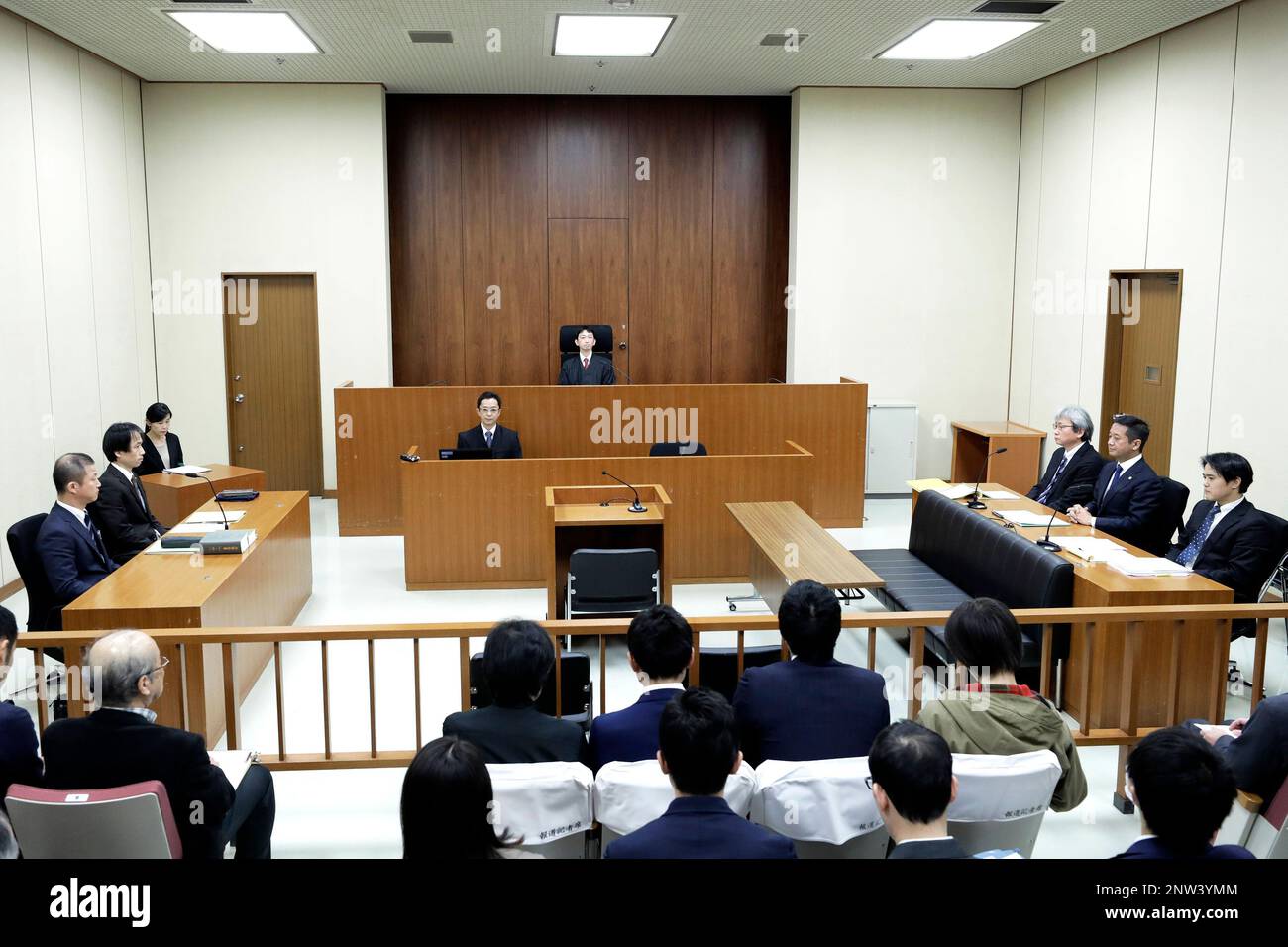 Judge Yuichi Tada, top center, and spectators sit in a courtroom ahead ...