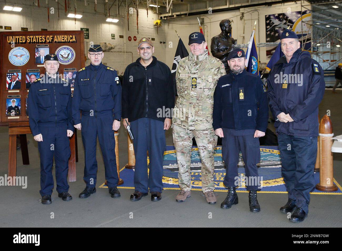 USS Gerald R. Ford (CVN 78) Command Master Chief Bryan Davis, Center ...