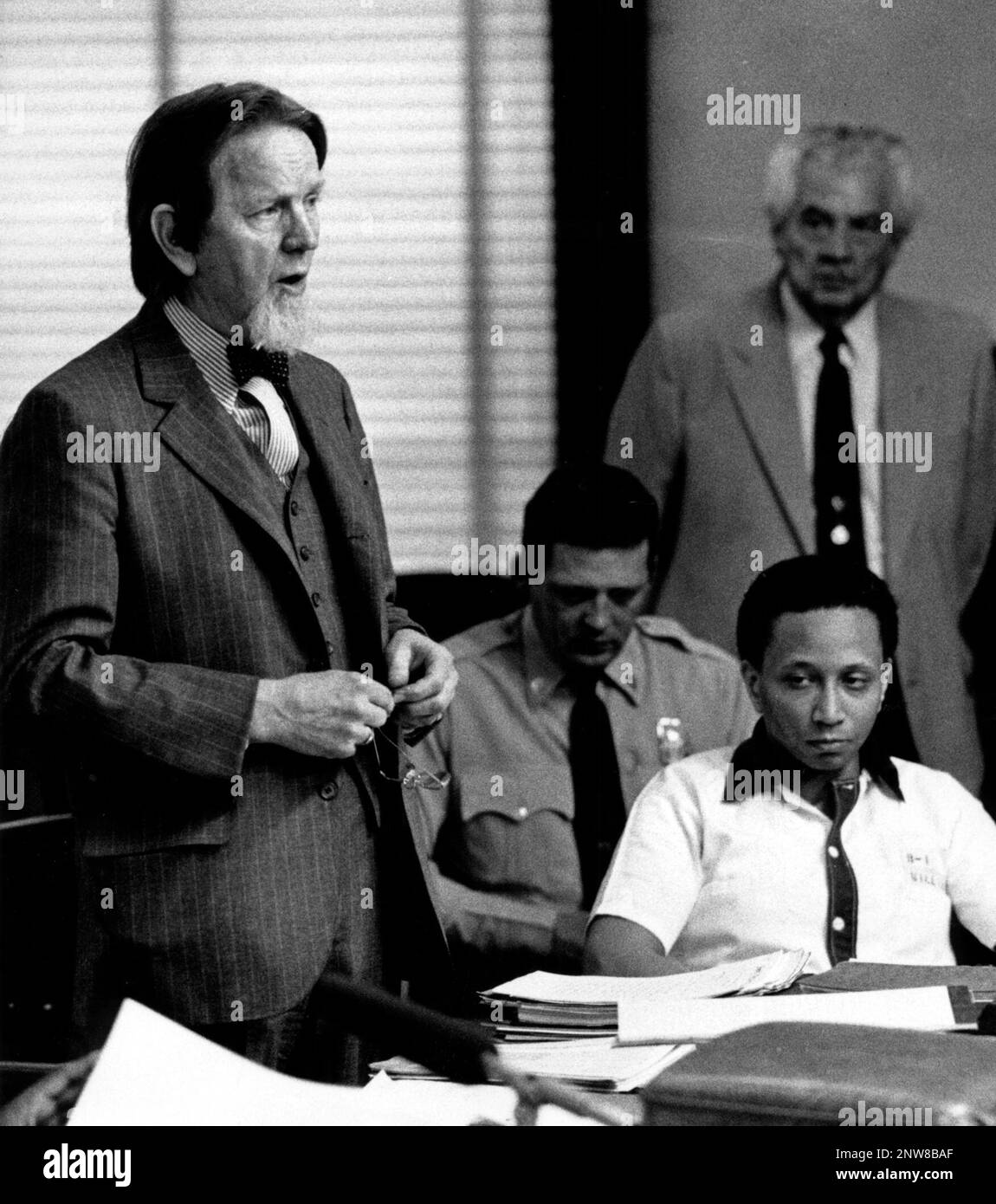 Wayne Williams, dressed in prison whites, look on as attorney Bobby Lee ...