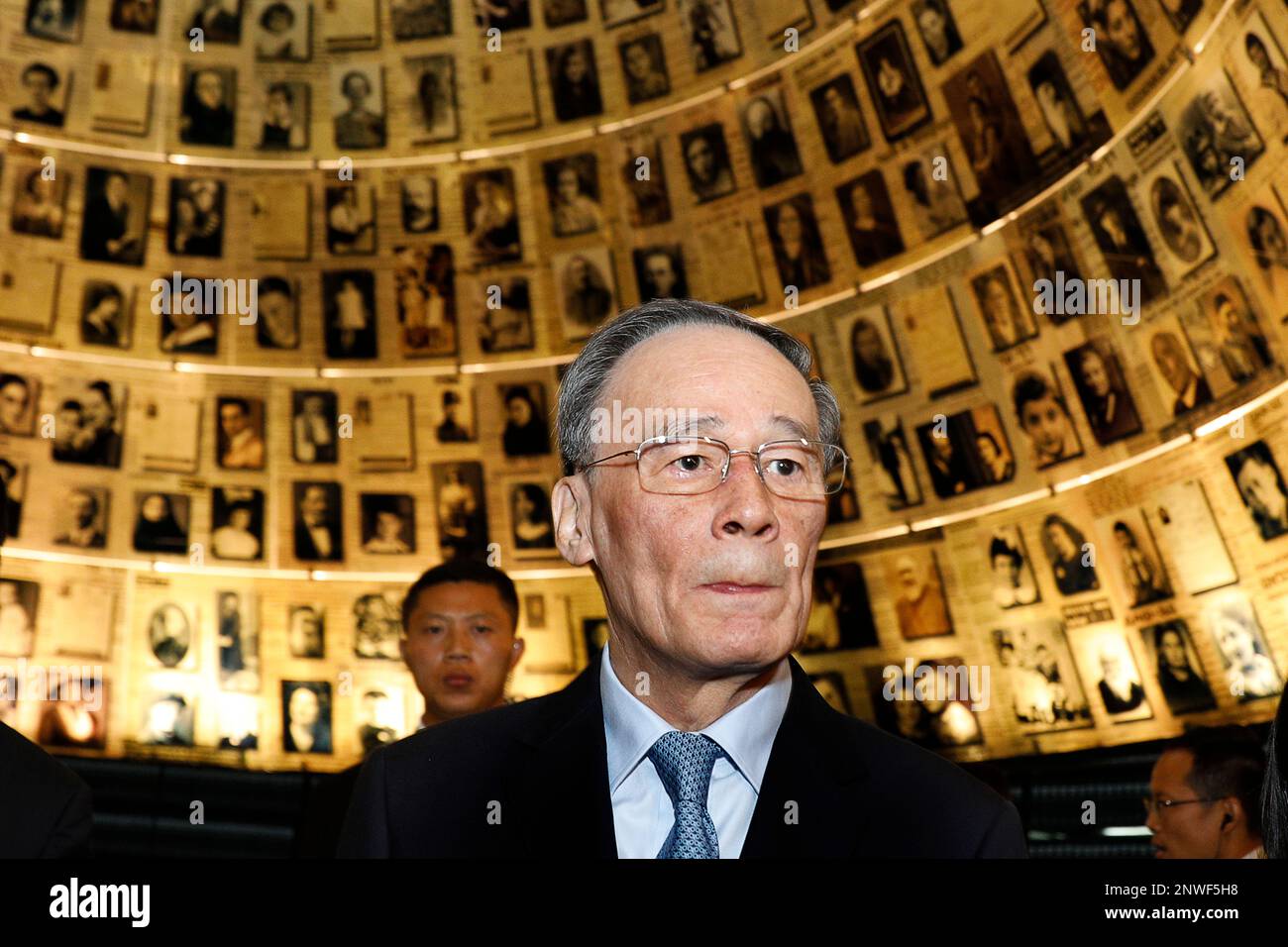 Chinese Vice President Wang Qishan looks at pictures of Jewish ...
