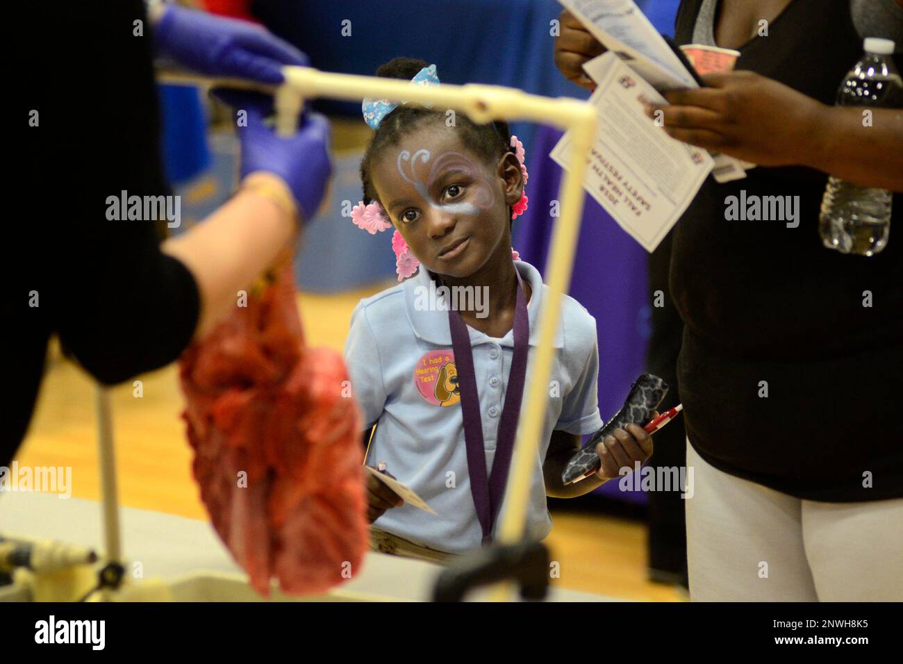 Raven Holmes, 5, watches as Delyte Chester, tobacco control coordinator ...