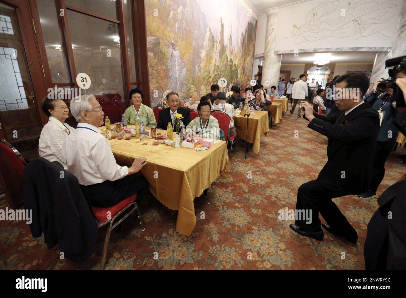South Korean Park Gab-il, 79, second from left, takes pictures with his ...