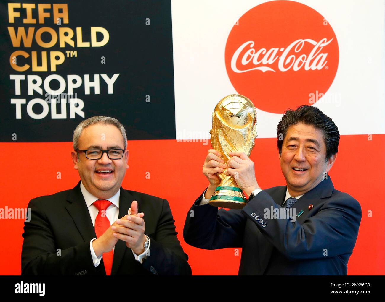 Japanese Prime Minister Shinzo Abe holds the FIFA World Cup trophy as ...