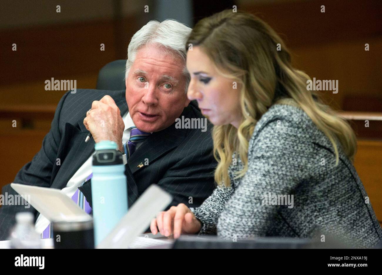Claud "Tex" McIver, left, speaks with his defense attorney Amanda Clark ...
