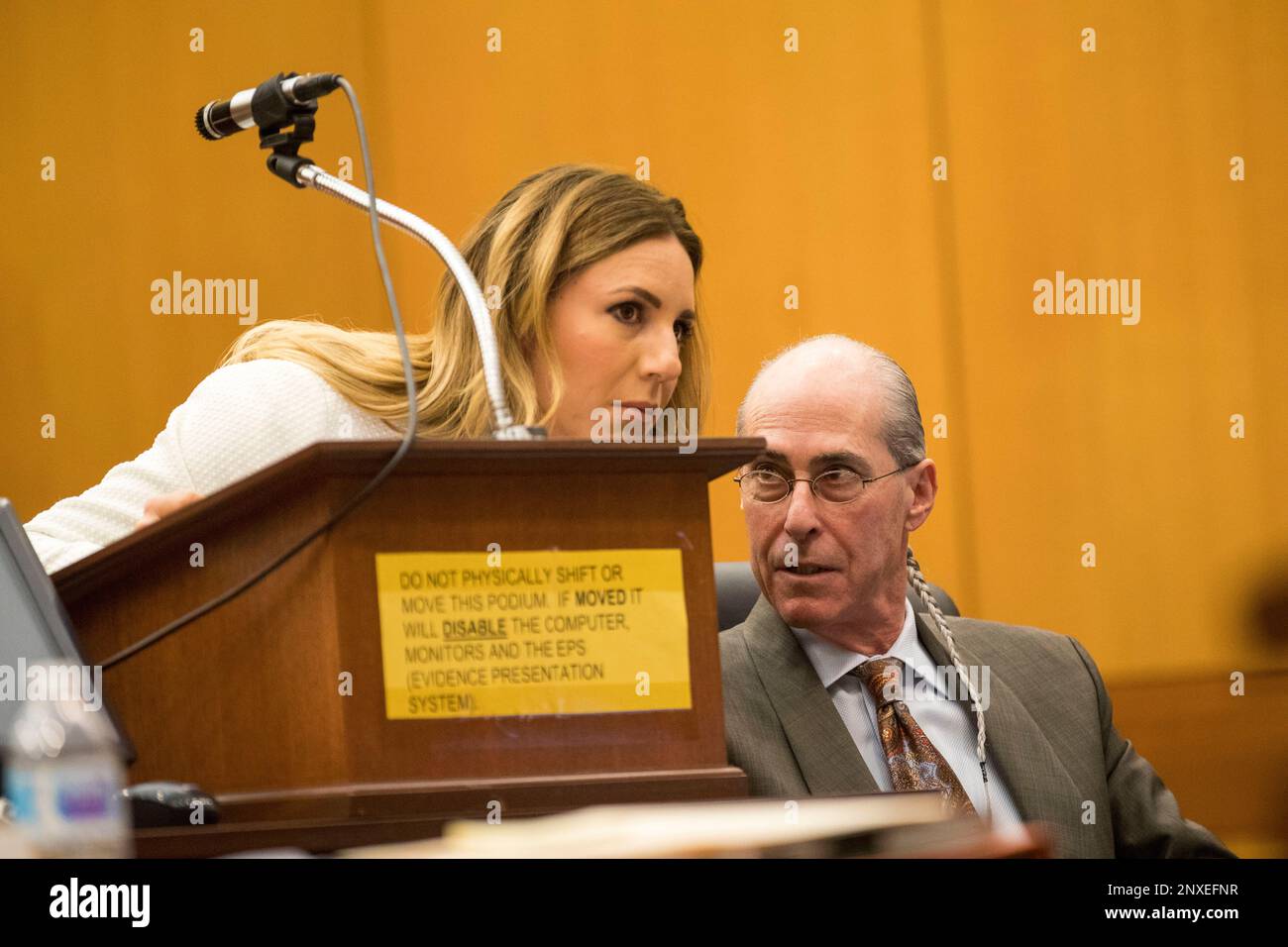 Defense Attorney Bruce Harvey, right, whispers to his team attorney, Amanda Clark Palmer, as she ...