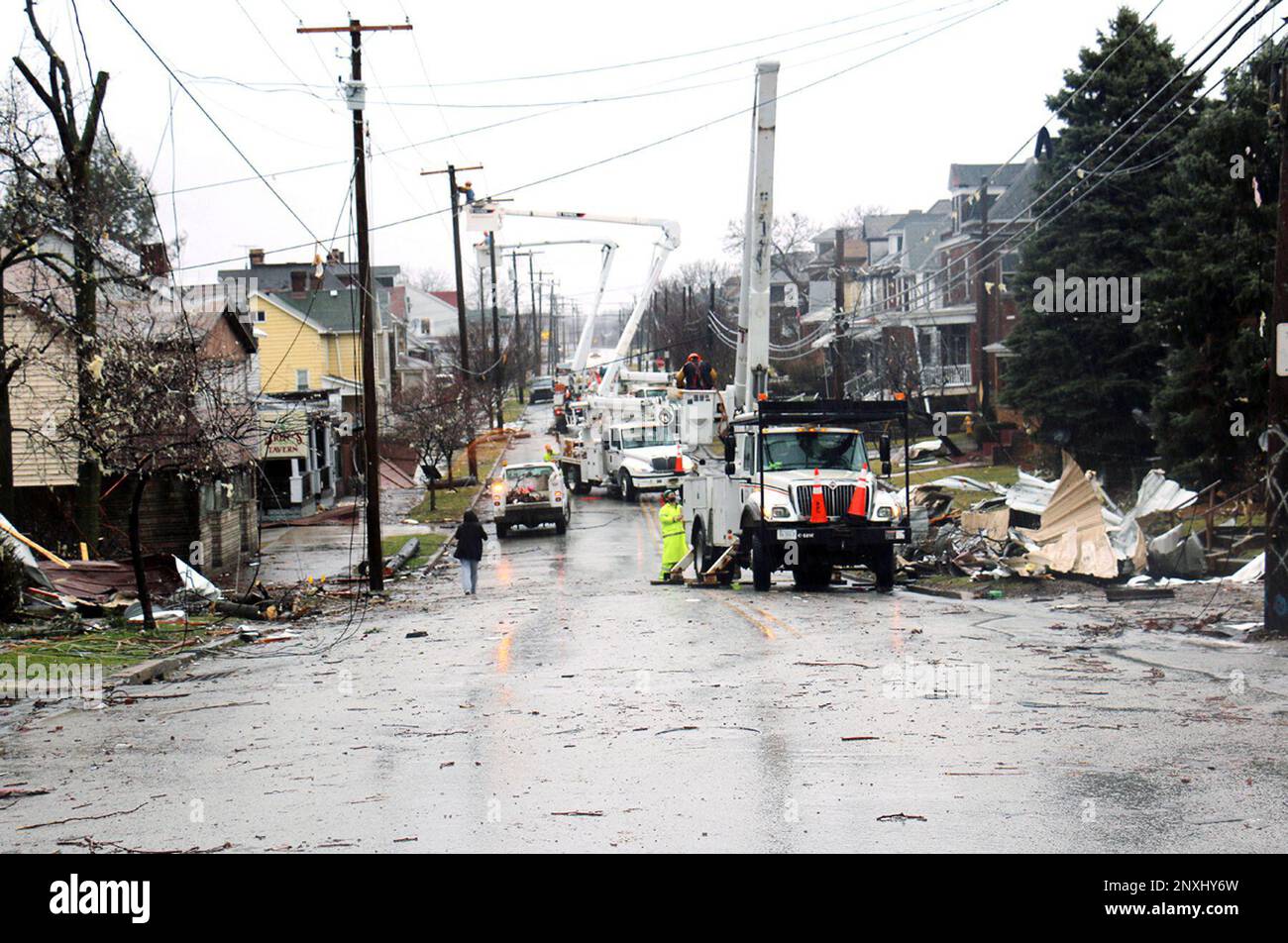 Line crews work to fix power lines along North Gallatin Avenue after a tornado ripped through ...