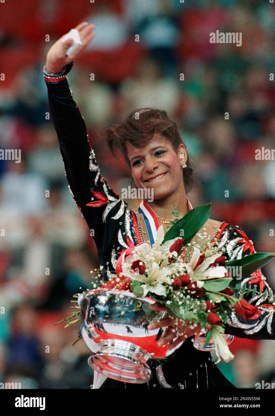 Debi Thomas waves to the crowd after being presented with the gold ...