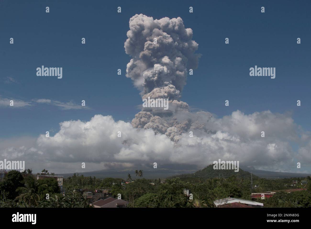 A huge column of ash shoots up to the sky during the eruption of Mayon ...