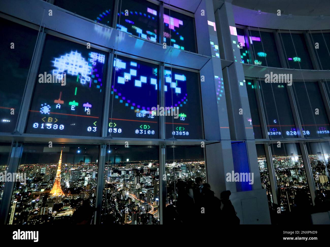 Space Invaders are projected on the window glasses of the Roppongi ...