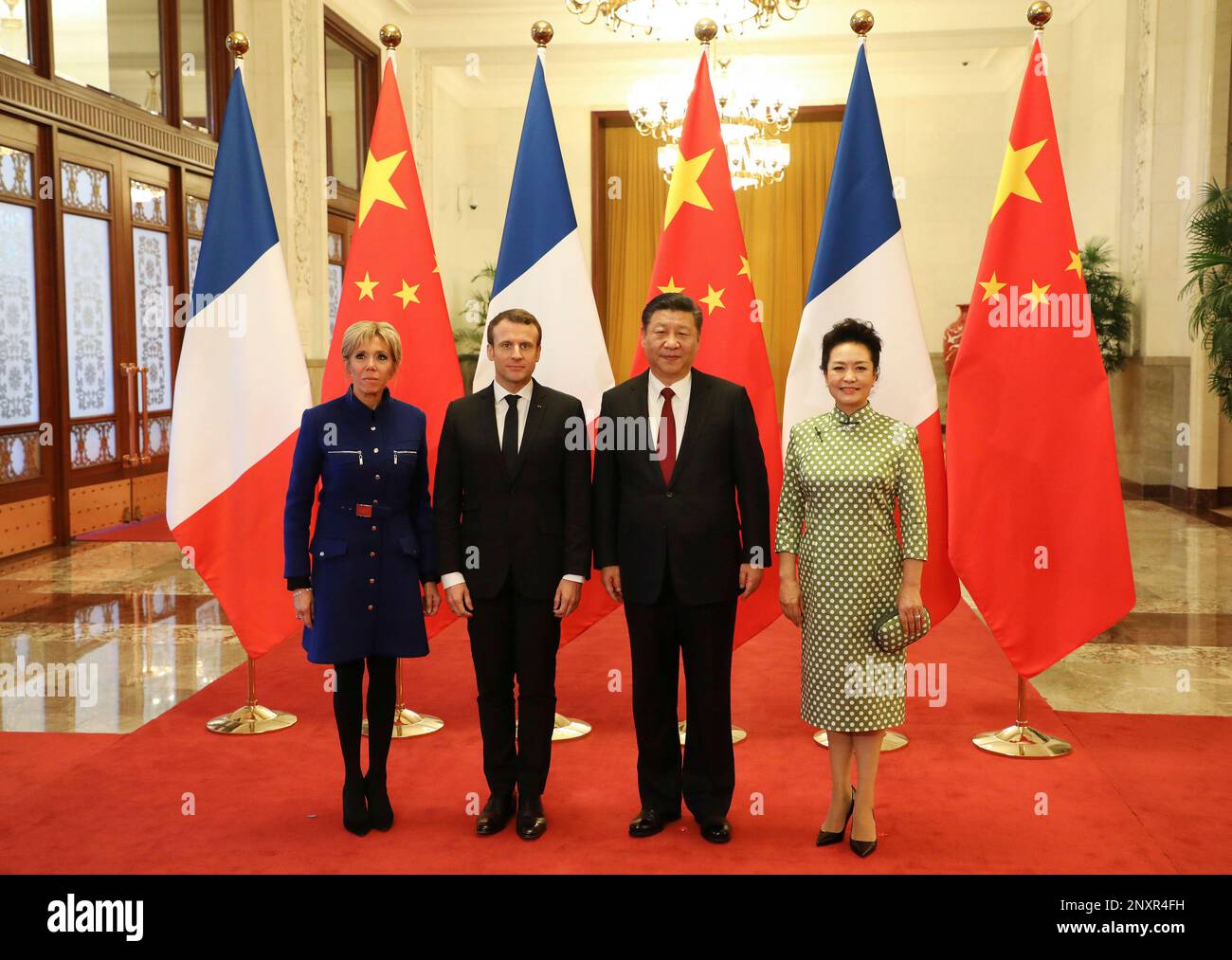 French President Emmanuel Macron and his wife Brigitte Macron pose with Chinese President Xi ...