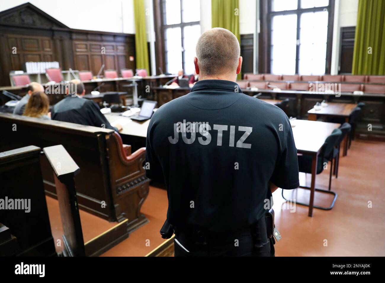 An officer of the court stands in a courtroom ahead of the trial of ...