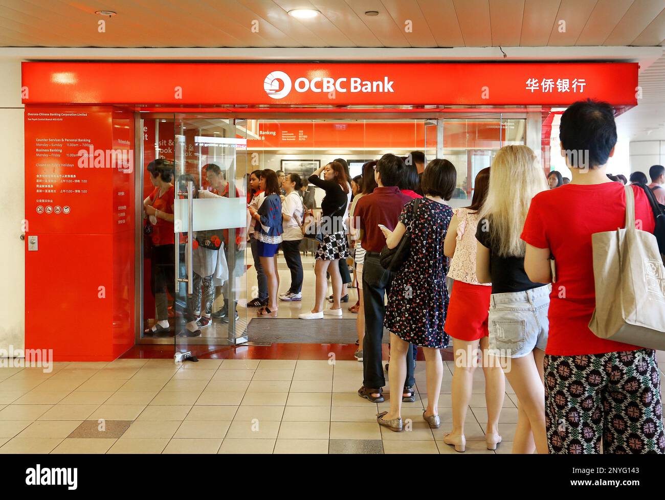 A queue at the cash deposit machines at the OCBC Bank outlet in Toa ...
