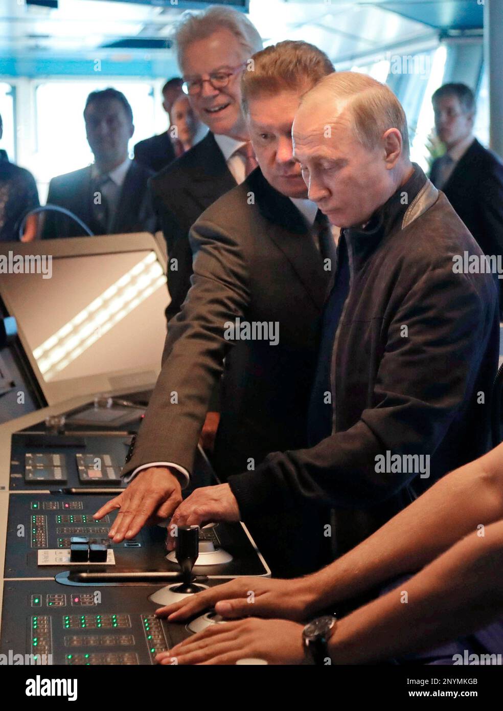 Russian President Vladimir Putin, right, flanked by Gazprom CEO Alexei ...