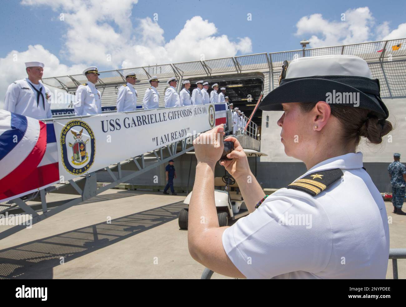 Lt. Miranda Williams of the U.S. Navy photographs sailors as they board ...