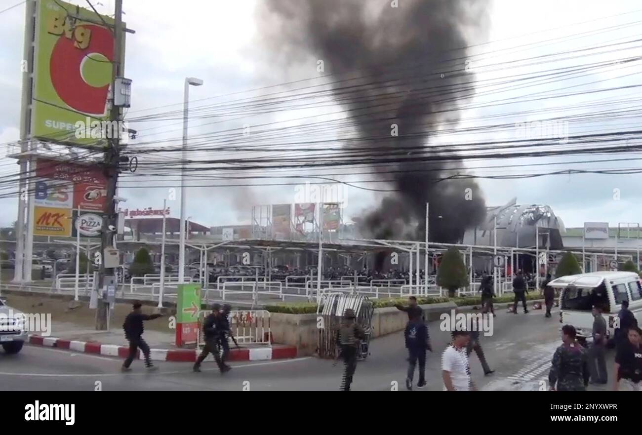 In this image made from video, smoke rises from an exploded vehicle ...