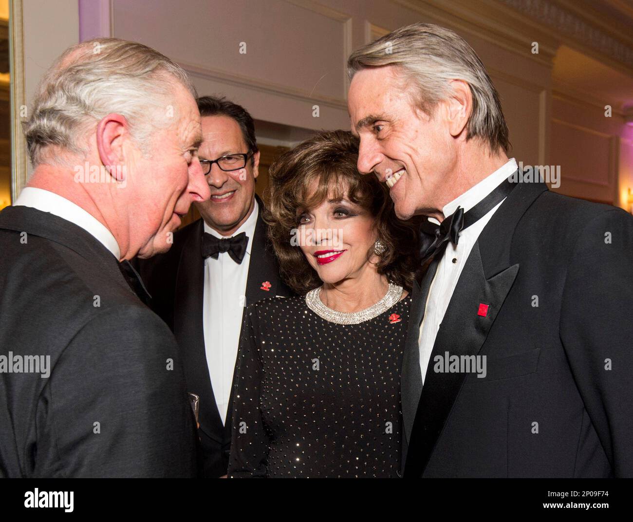 Britain's Prince Charles, left, speaks to actress Joan Collins, centre ...