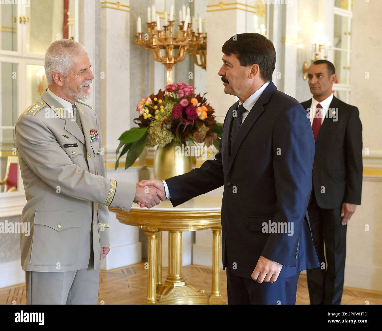 Hungarian President Janos Ader, right, welcomess Chairman of the NATO ...