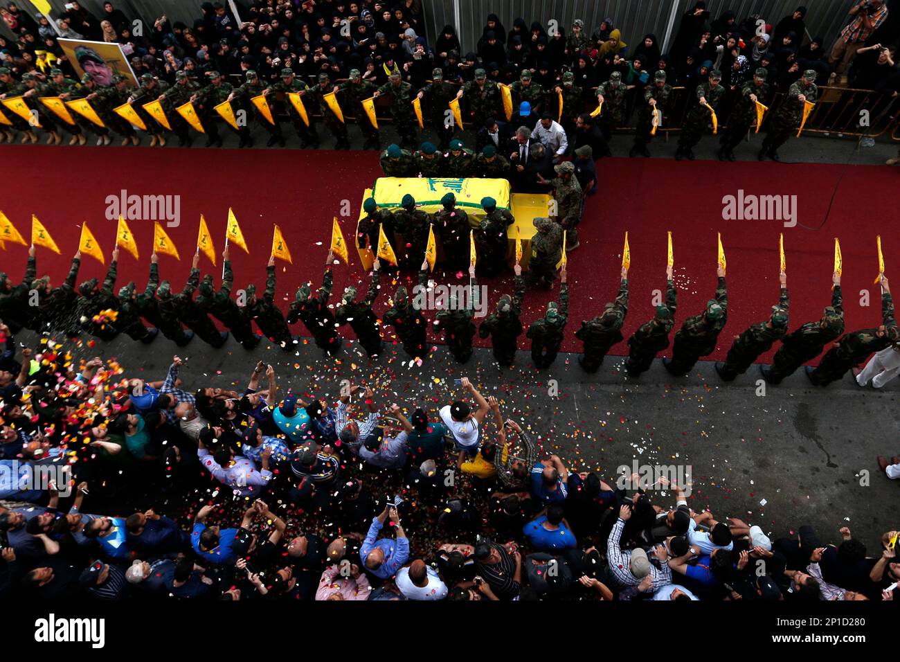 Hezbollah fighters carry the coffin of their slain commander Mustafa ...