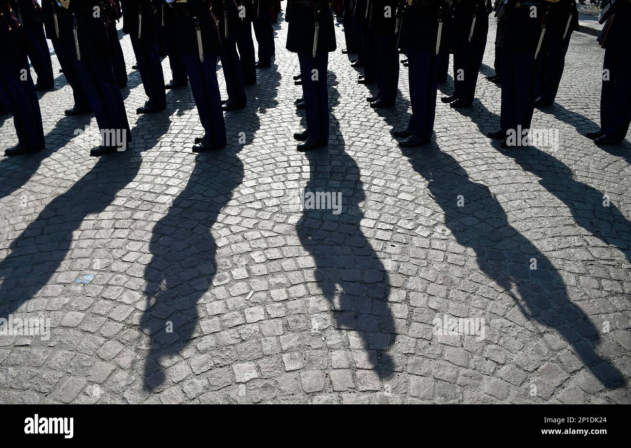 The honor guards cast their shadows as they take part at commemorations ...