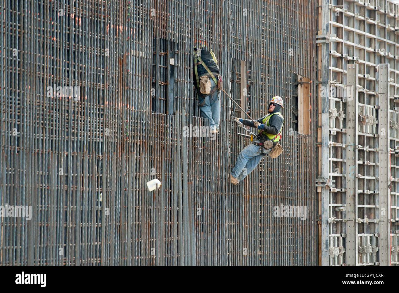 Laborers work on a wall at the construction site of the new Karegnondi ...