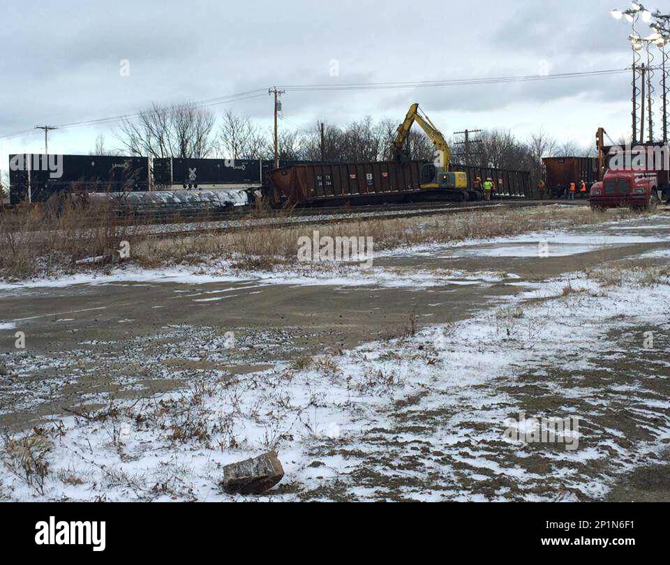 Crews work to clear the site of a 16-car Norfolk Southern freight train ...