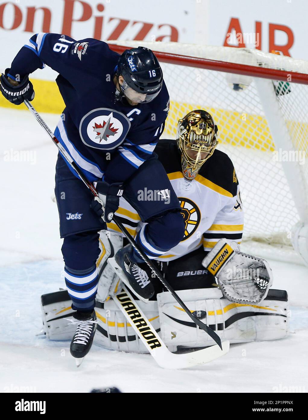 Winnipeg Jets' Andrew Ladd (16) attempts to beat Boston Bruins ...