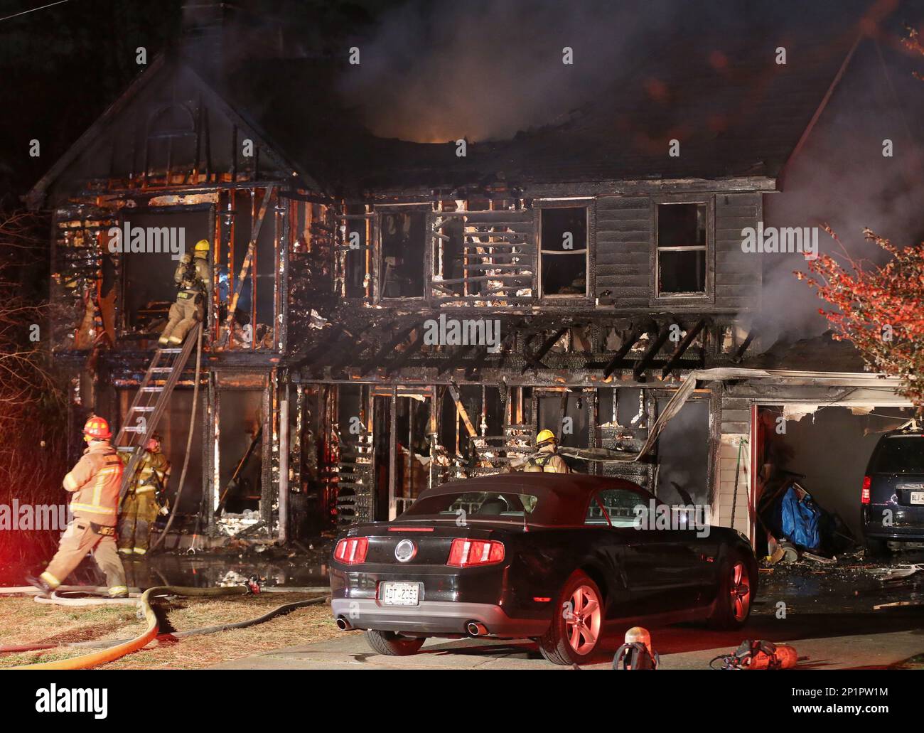 Gwinnett County firefighters work at the scene of a house fire in ...