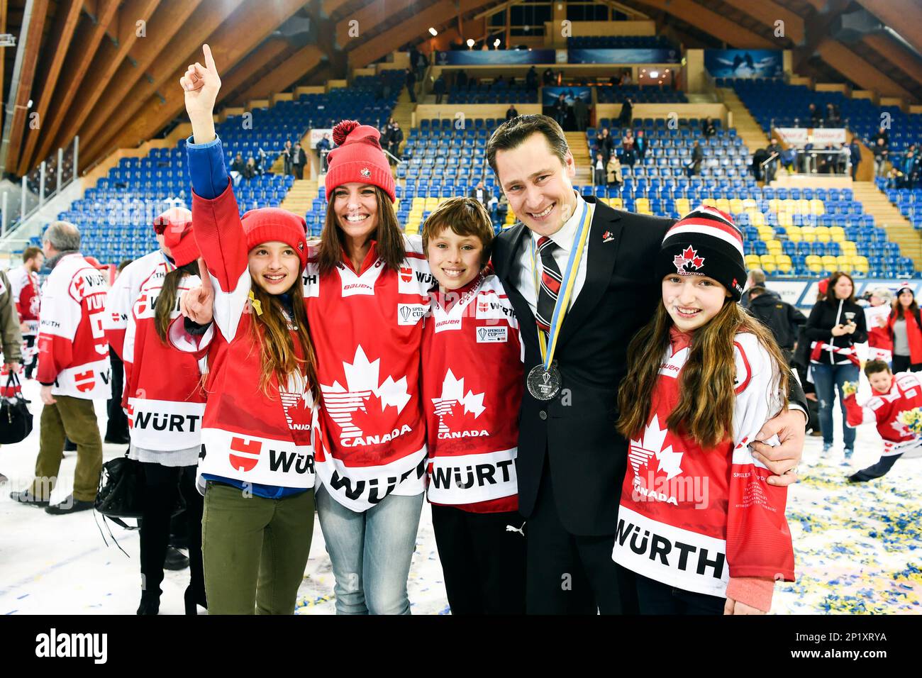 Team Canada's head coach Guy Boucher and wife Marsha pose with children ...