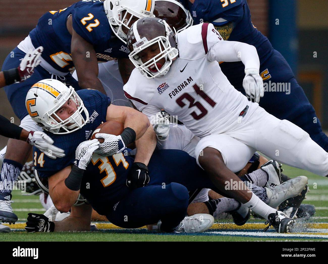 Chattanooga running back Derrick Craine, left, falls to the ground ...