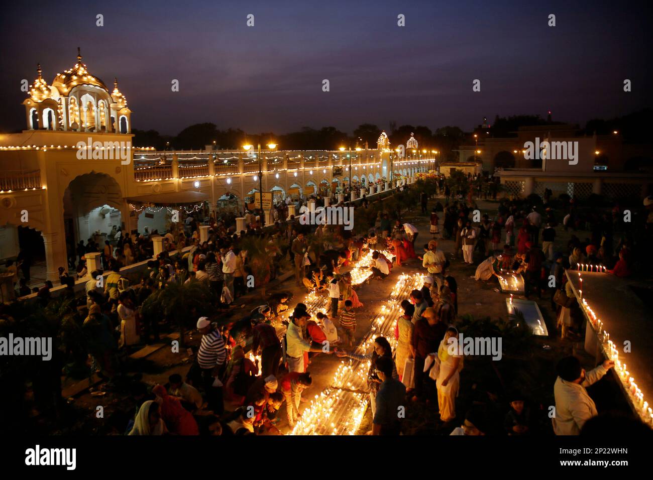 Sikhs light candles at the illuminated Gurudwara Bangla Sahib, a Sikh ...