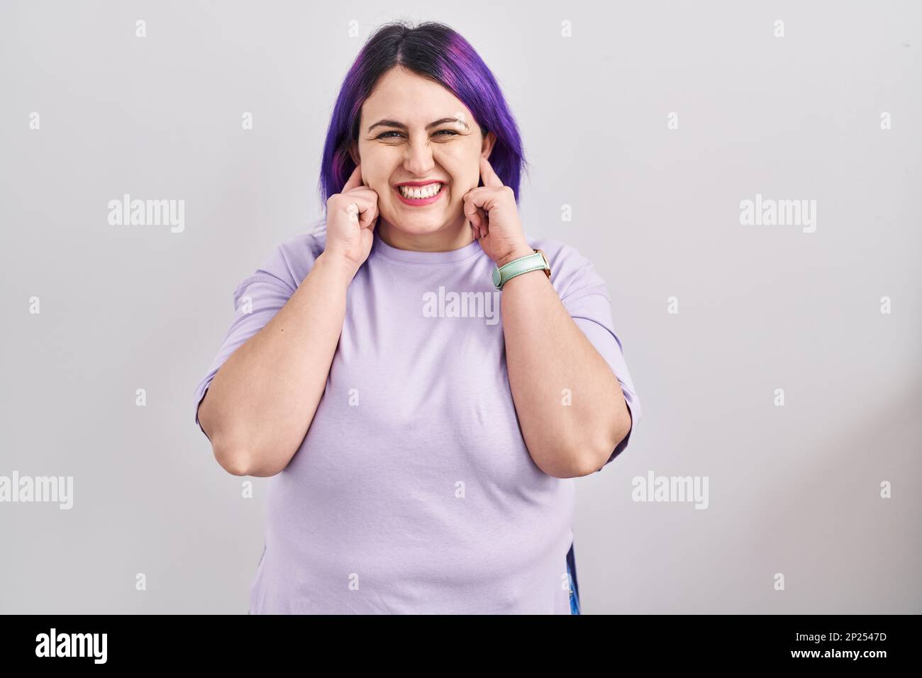 Große Frau mit lila Haaren, die über einem isolierten Hintergrund steht ...
