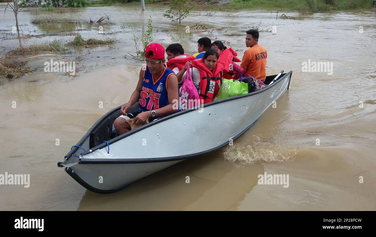In this photo provided by the Philippine Air Force, a family rides a ...