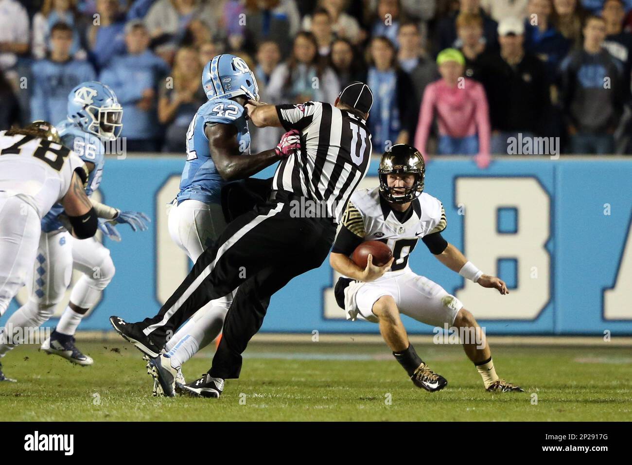 17 October 2015: Umpire Rich McMahan (U) is knocked over by UNC's ...