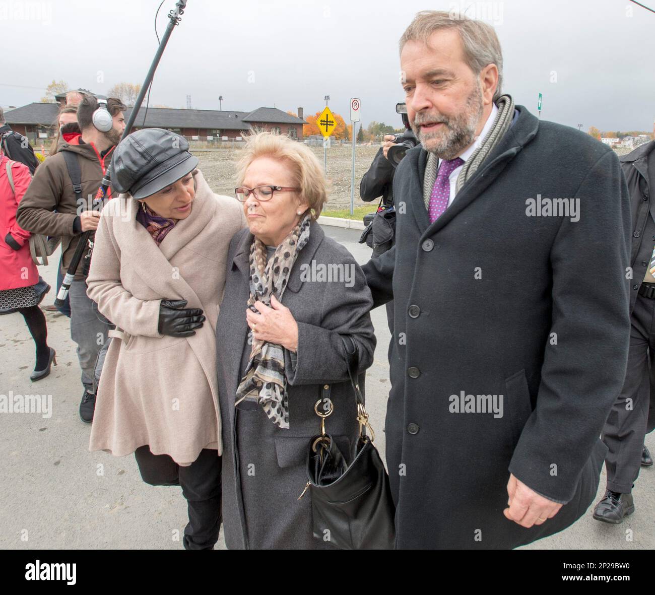 NDP Leader Tom Mulcair, Mayor Colette Roy-Laroche, center, and ...