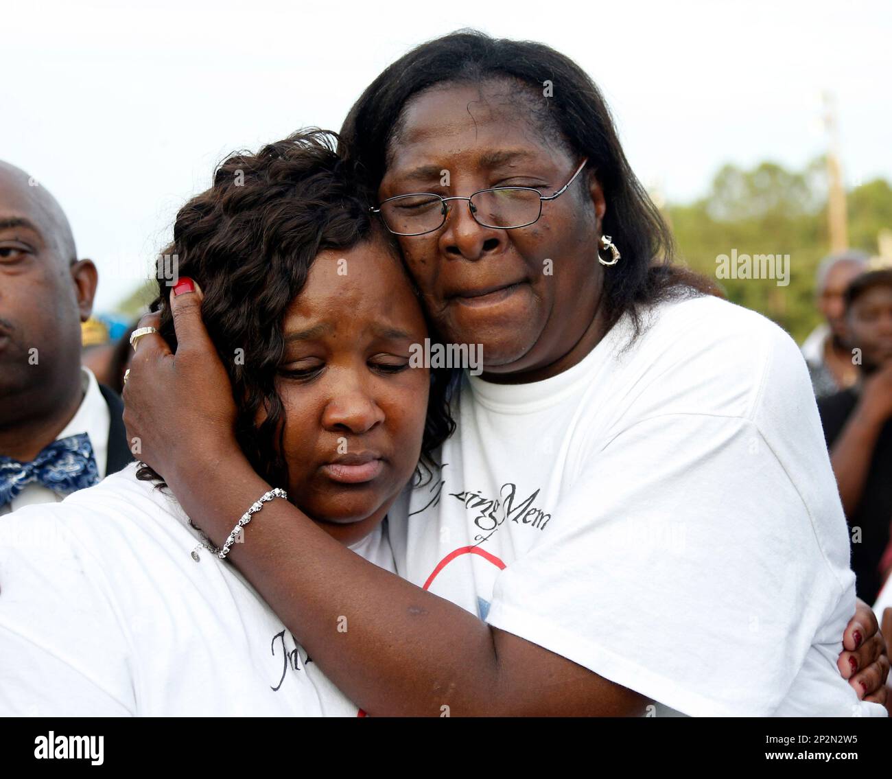 Frances Sanders, mother of Jonathan Sanders, right, hugs his sister ...