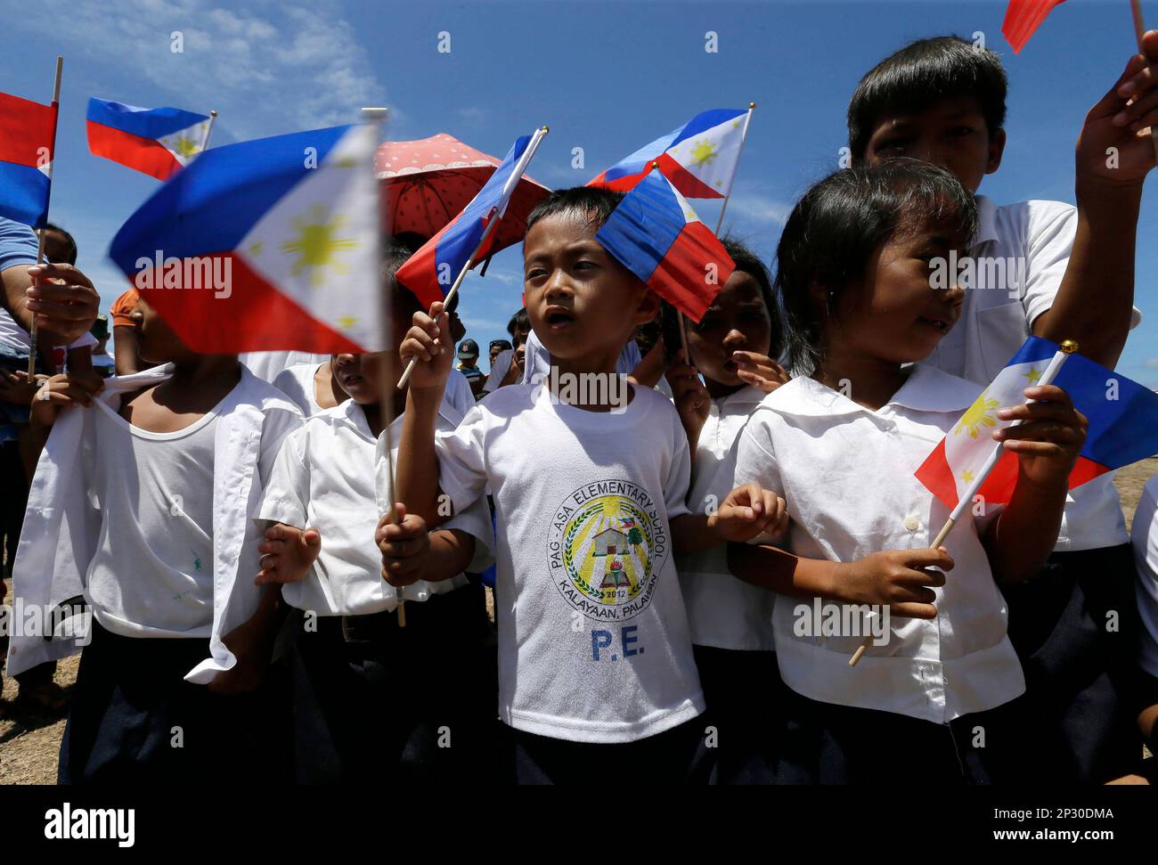 Elementary school children wave national flags of the Philippines as ...