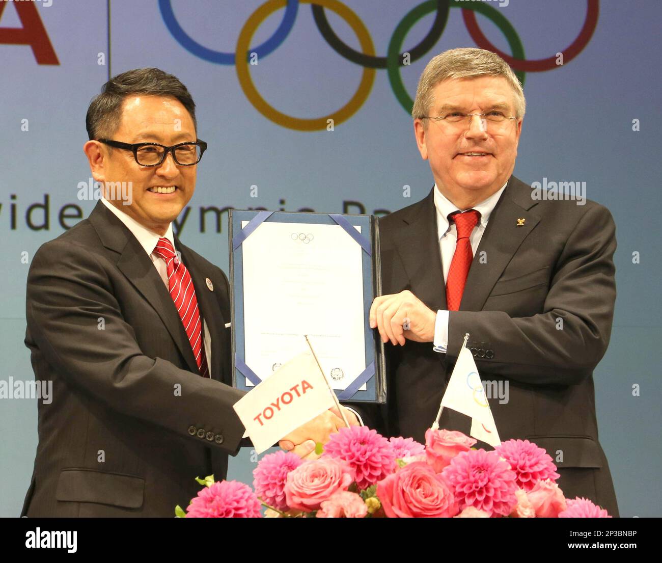 Akio Toyoda (L), President of Toyota Motor Corp. and Thomas Bach ...
