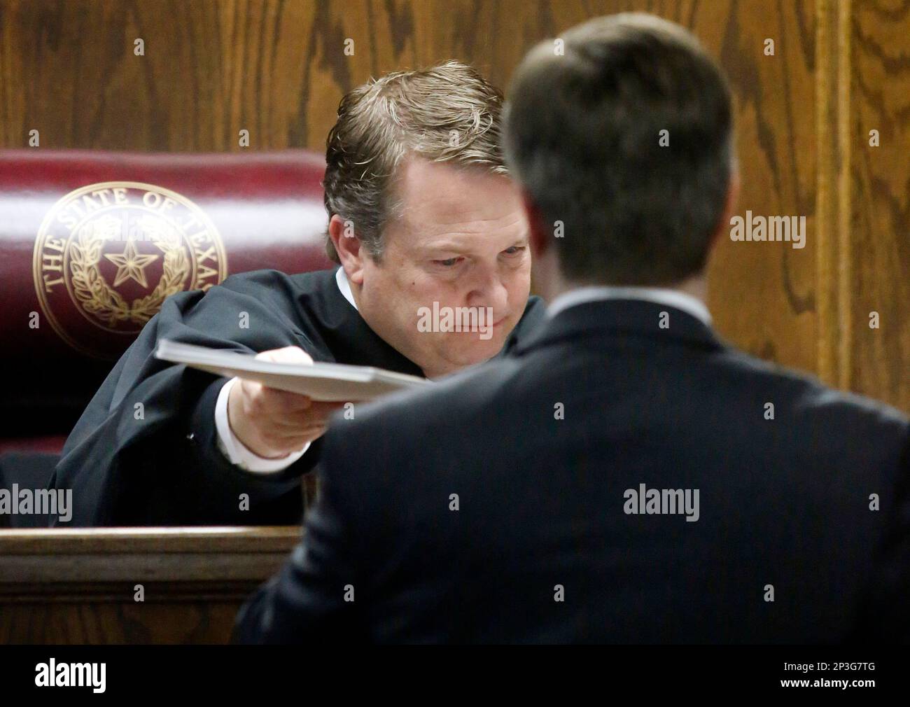 State District Judge Jason Cashon hands back photos, some which are ...