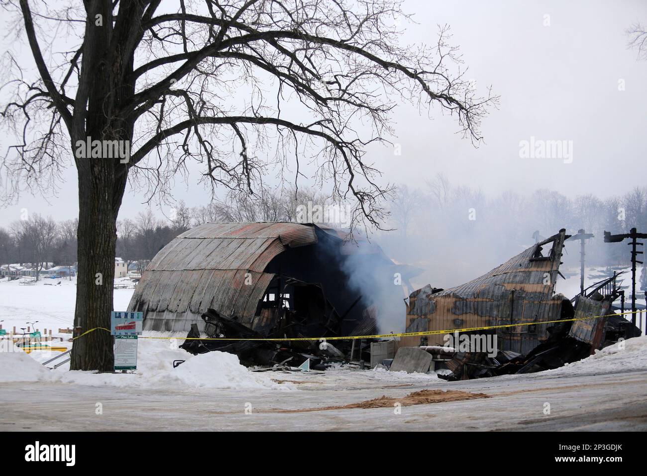 A structure smolders after a Sunday night fire destroyed Pat Cooper's ...