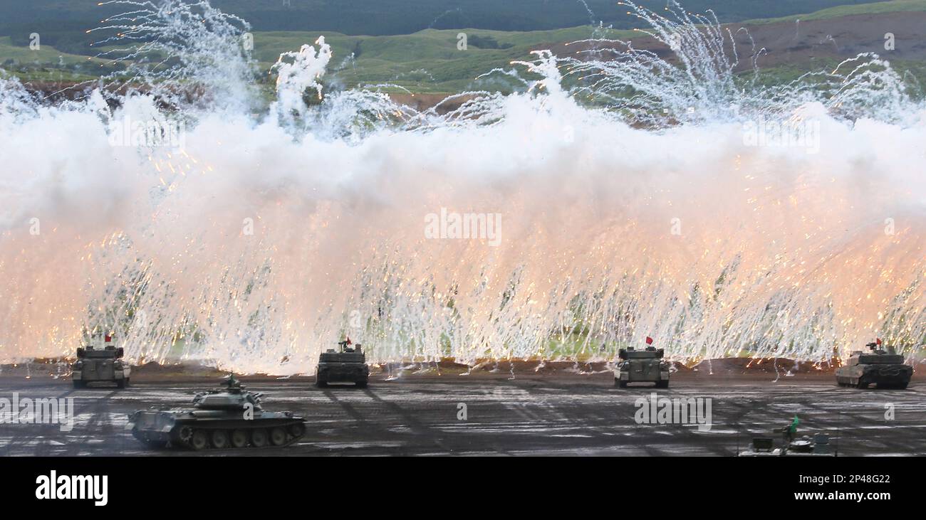 Members of Japan’s Ground Self Defence Force deploy a live-firing drill ...